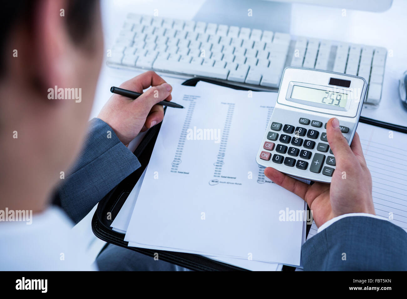 Businessman using his calculator Stock Photo - Alamy