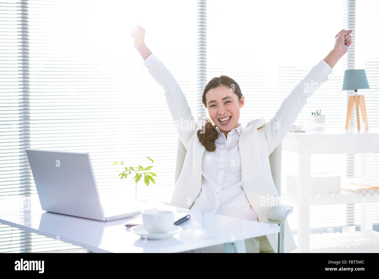 Businesswoman rejoicing with arms outstretched Stock Photo - Alamy