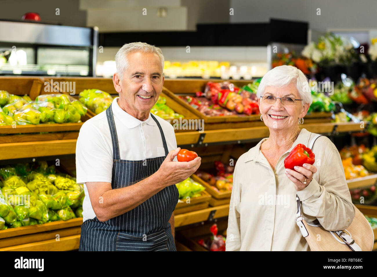 Senior customer and worker discussing vegetables Stock Photo - Alamy