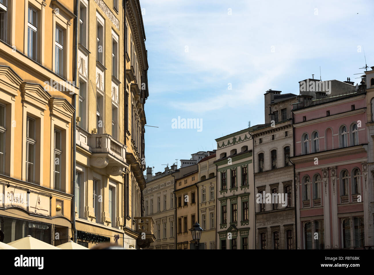 Colorful building facades against a blue sky in Krakow, Poland Stock ...
