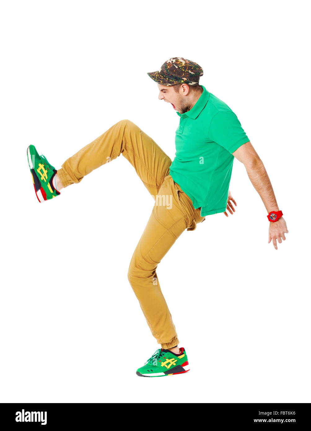 Fullbody portrait of young male kicking in studio isolated on white ...