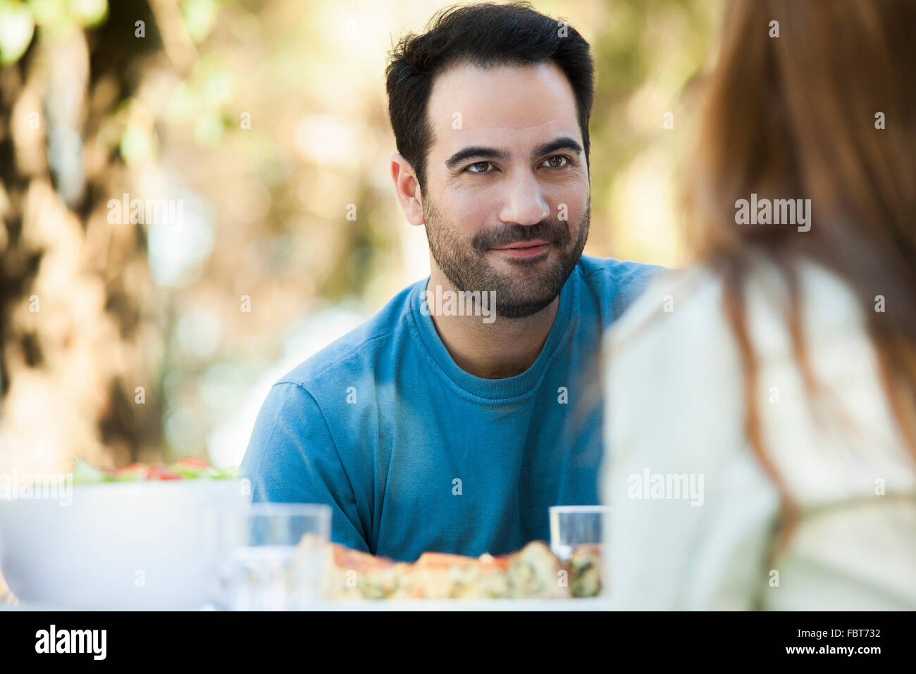 Man having meal outdoors with date Stock Photo - Alamy