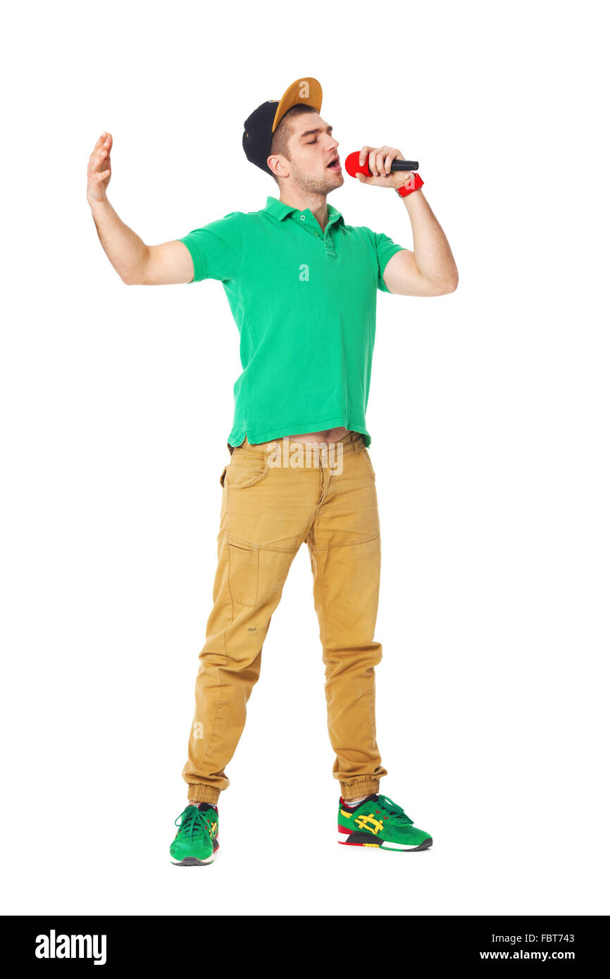 Portrait of young male hip hopper singing in studio isolated on white ...
