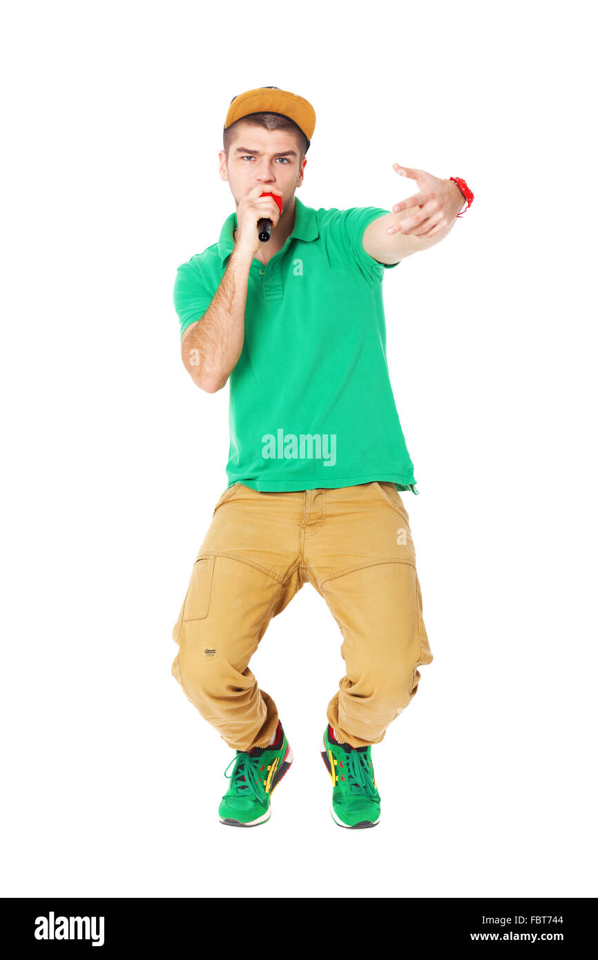 Portrait of young male hip hopper singing in studio isolated on white ...