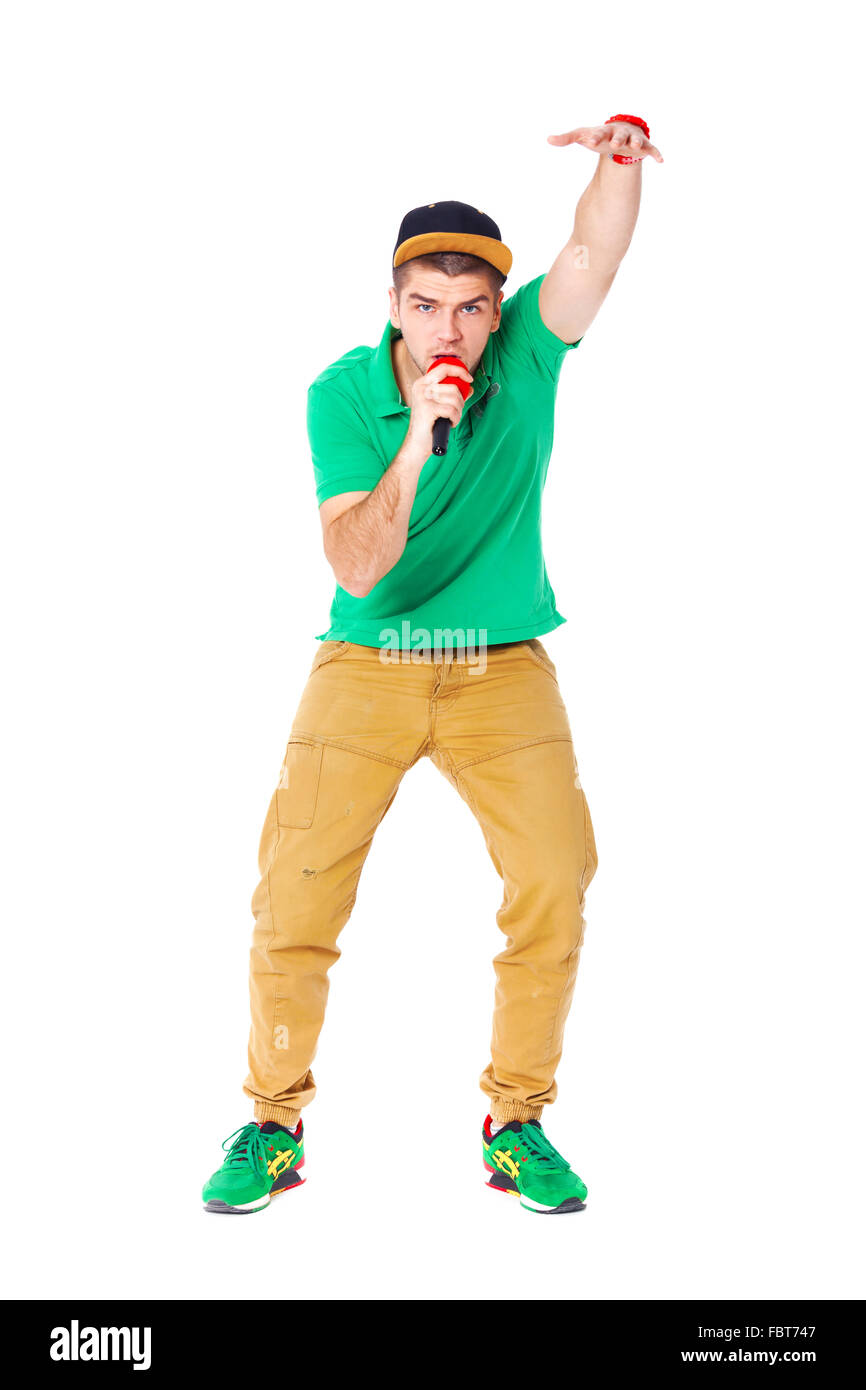 Portrait of young male hip hopper singing in studio isolated on white ...