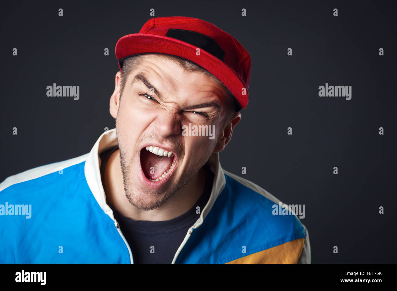 Studio portrait of screaming young guy in studio Stock Photo - Alamy