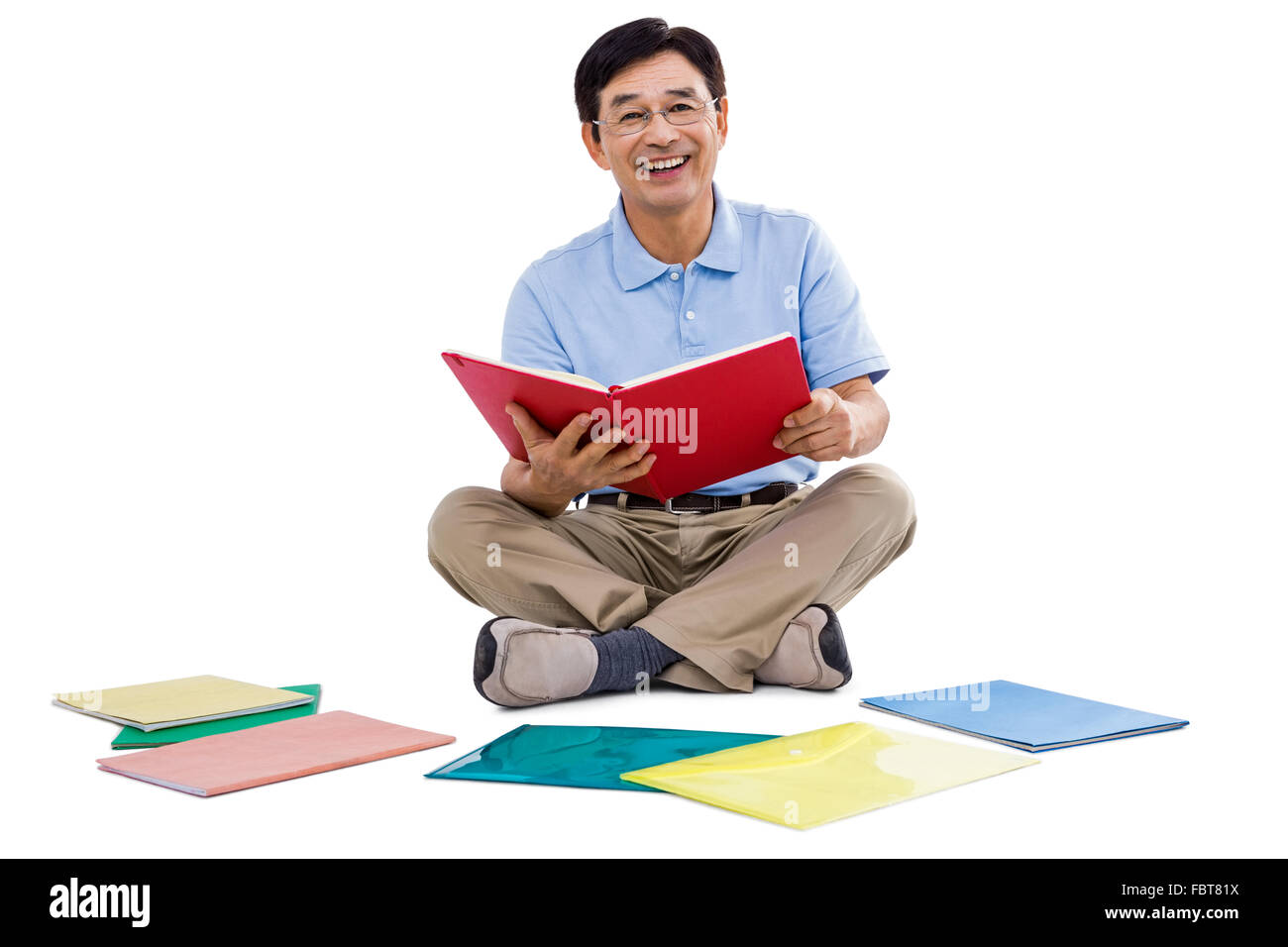 Smiling man reading books Stock Photo - Alamy