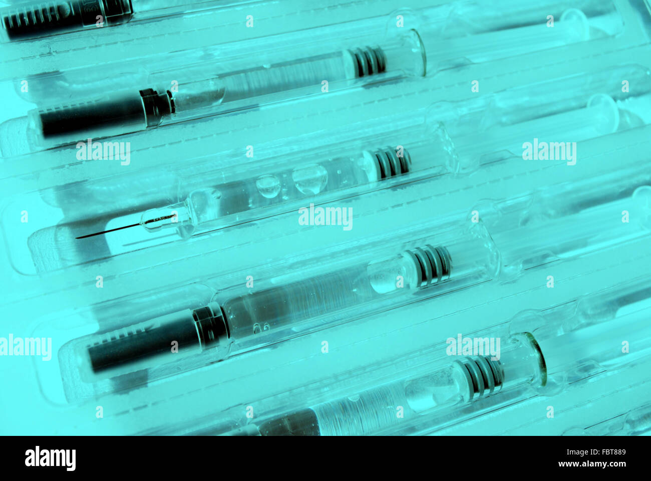 many syringes in package in blue light Stock Photo - Alamy