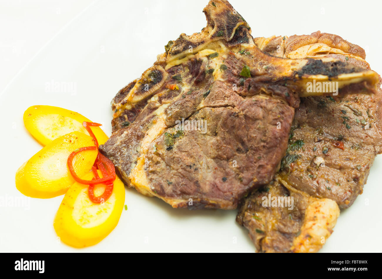 Delicious cutlet of beef perfectly cooked and placed upon white dinner ...