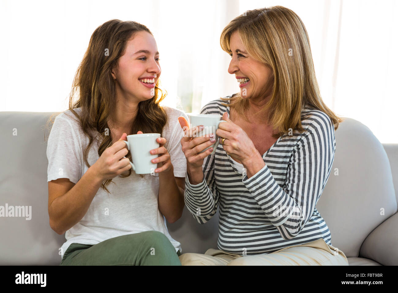 Mother and daughter drink tea Stock Photo - Alamy