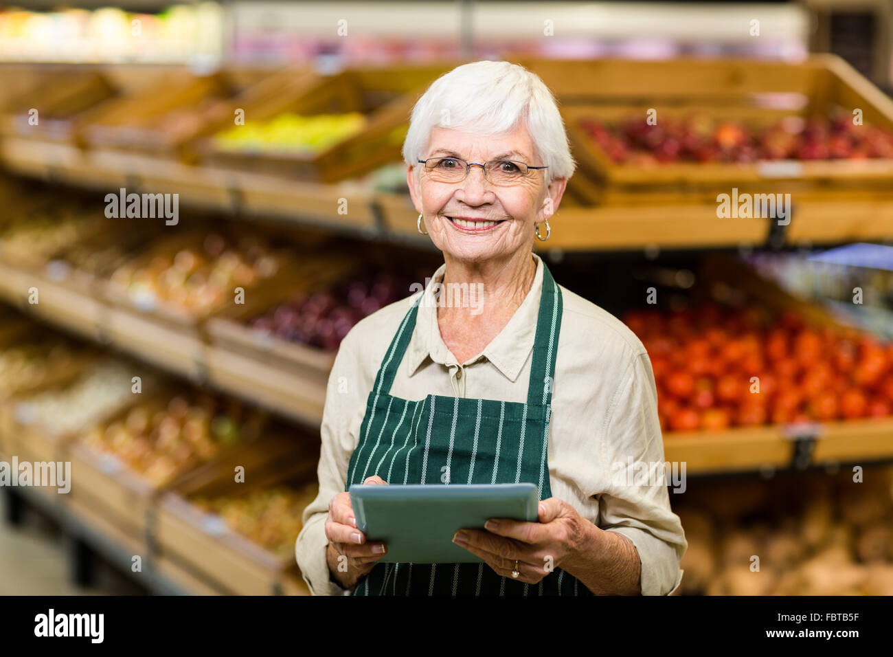 Supermarket employee using tablet hi-res stock photography and images ...