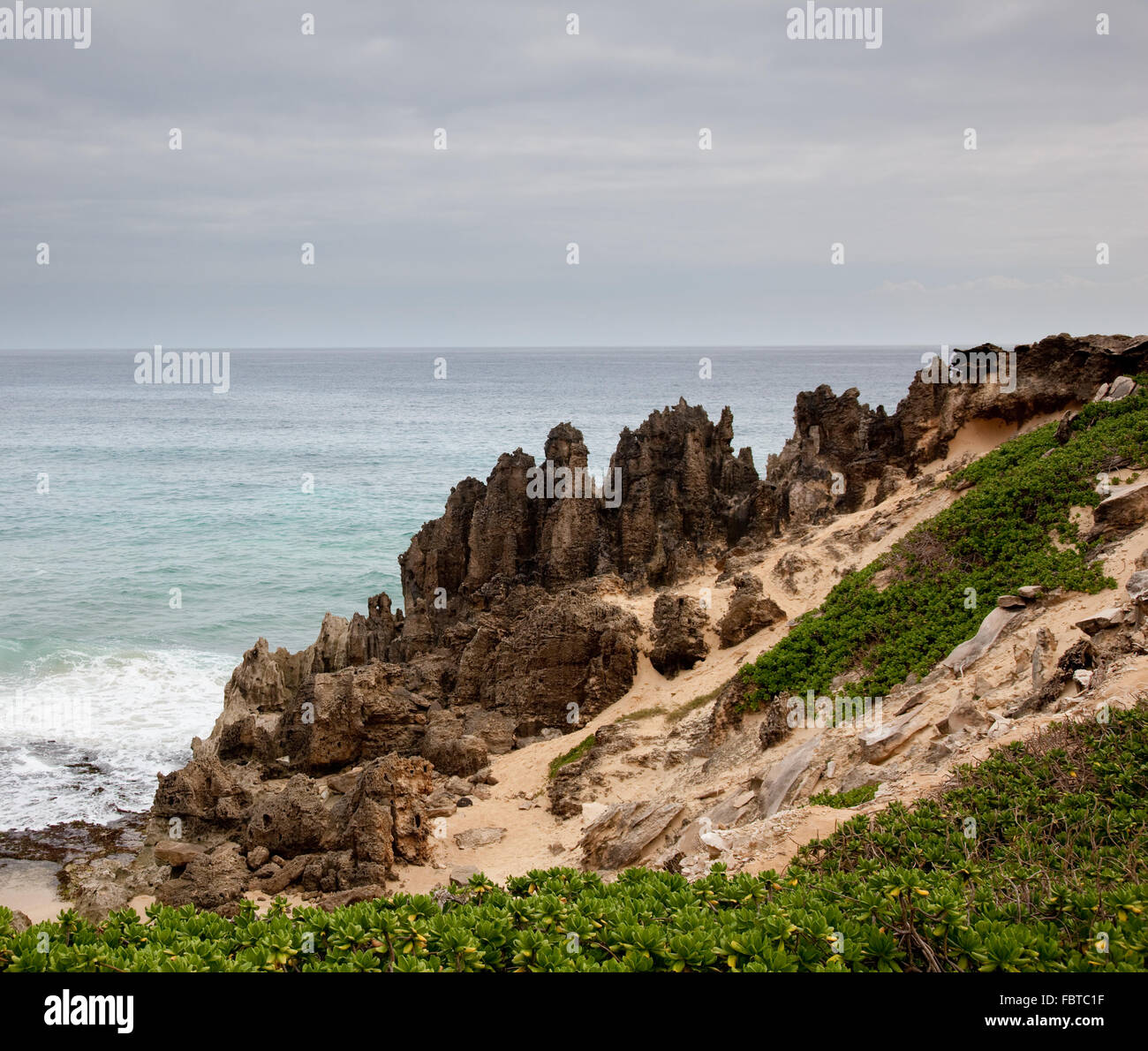 South Shore of Kauai with eroded rocks against the ocean Stock Photo ...