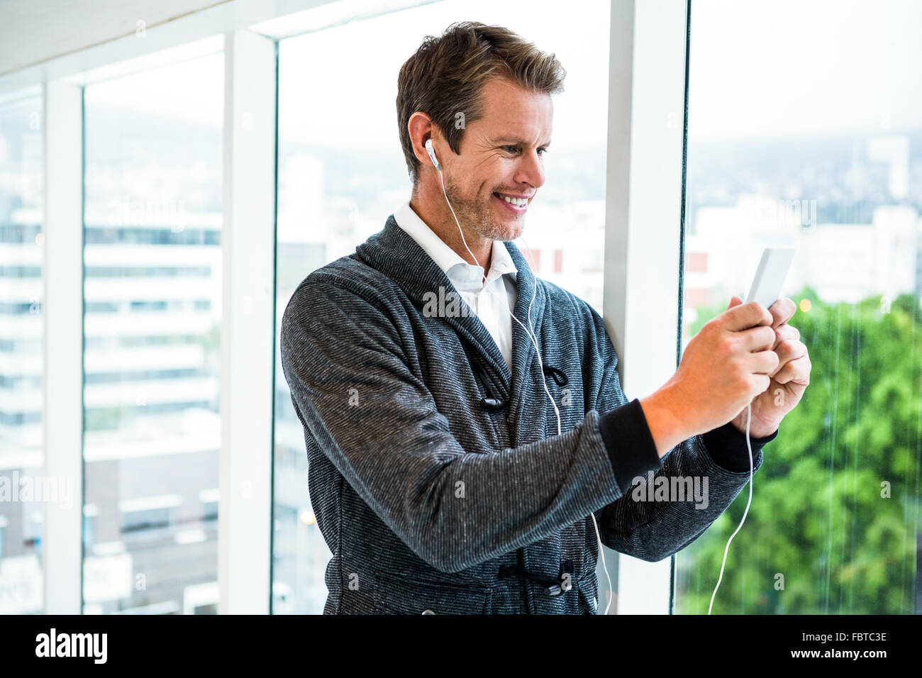 Man headphones using mobile phone hi-res stock photography and images ...