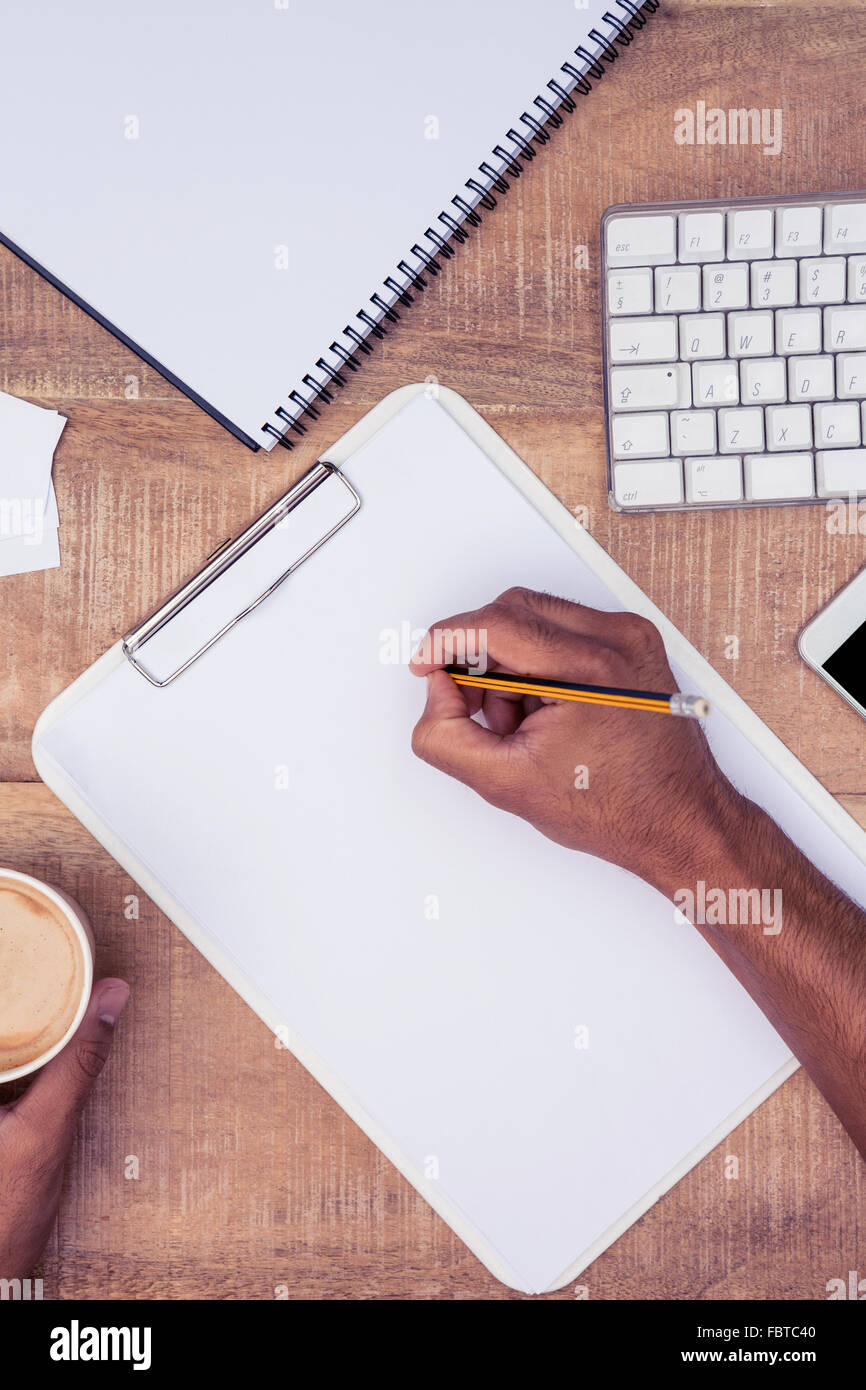 Cropped image of businessman writing on pad Stock Photo - Alamy