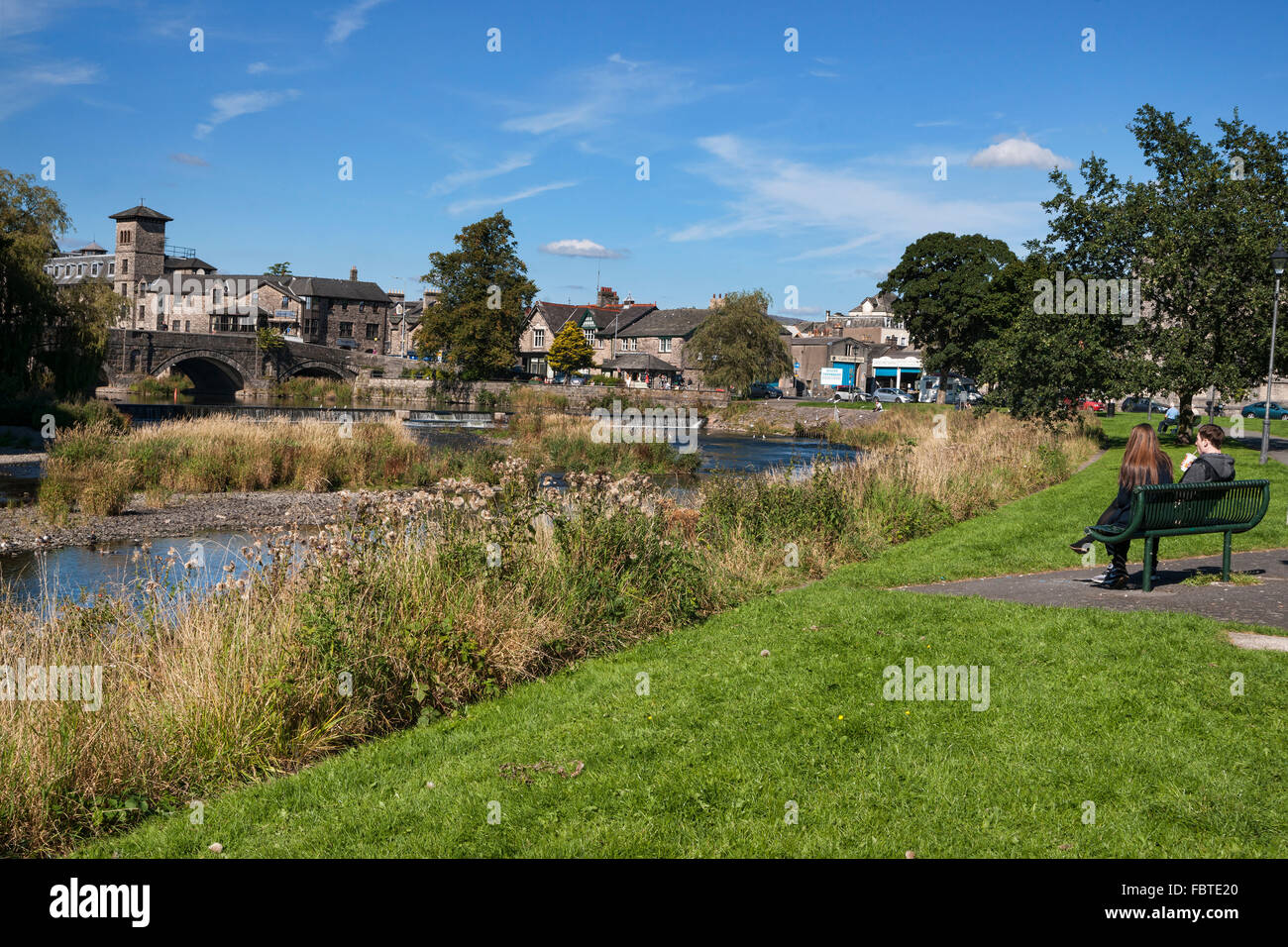 Relaxing beside the River Kent in Kendal, Cumbria, North England UK ...