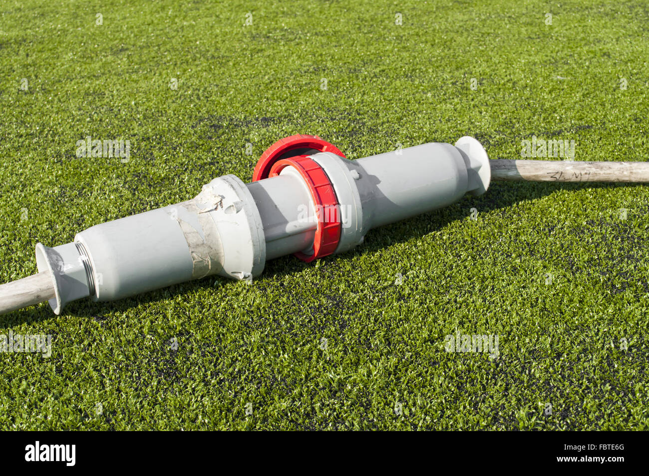 Connected wire in a soccer field on grass Stock Photo - Alamy