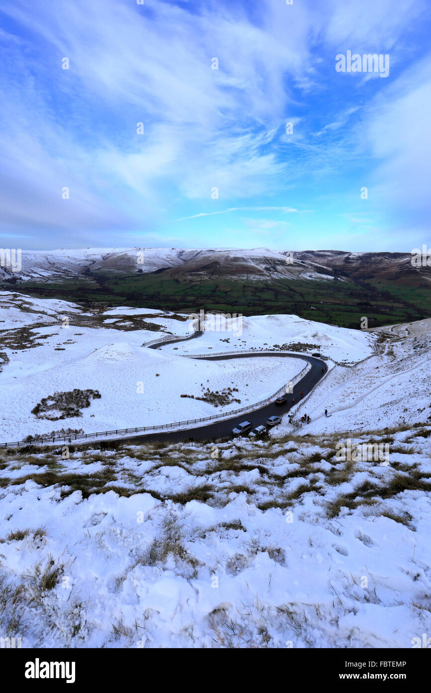 Winding road to Edale below snowy Mam Tor and distant Kinder Scout near ...