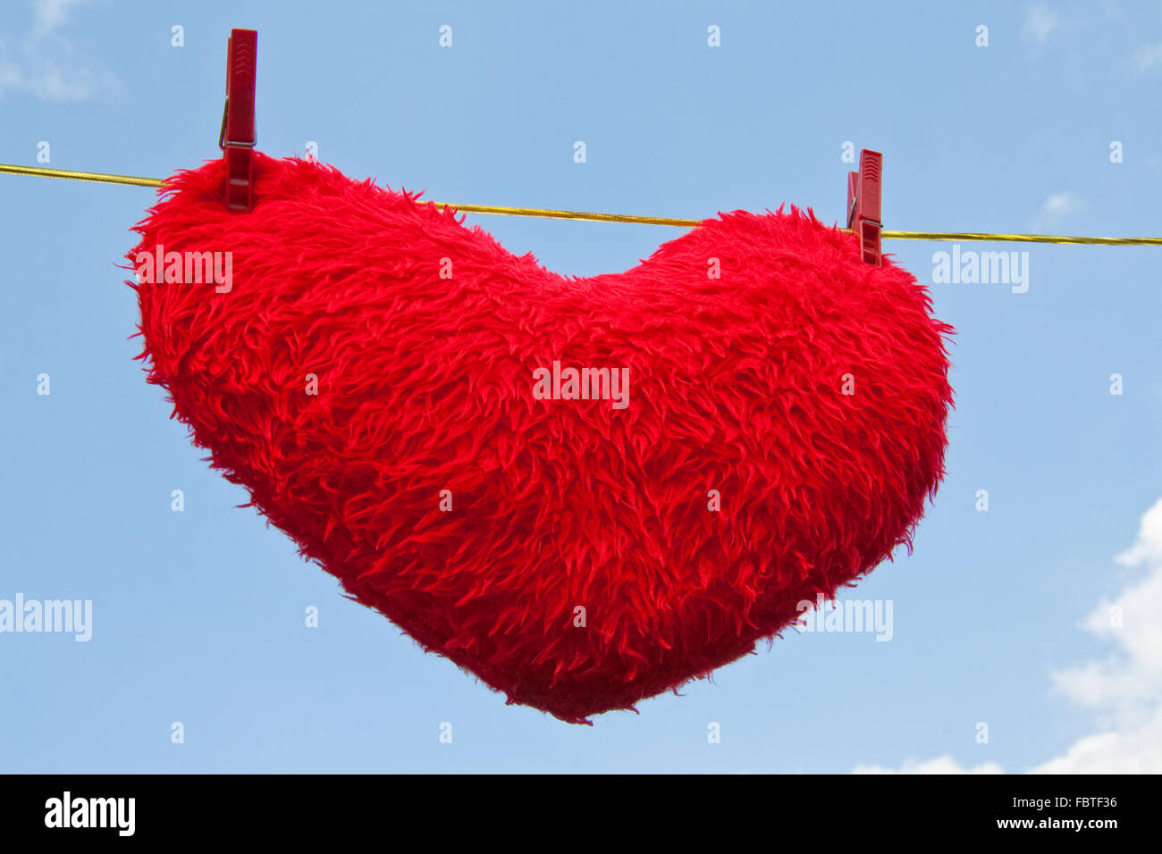 Heart on clothesline Stock Photo - Alamy