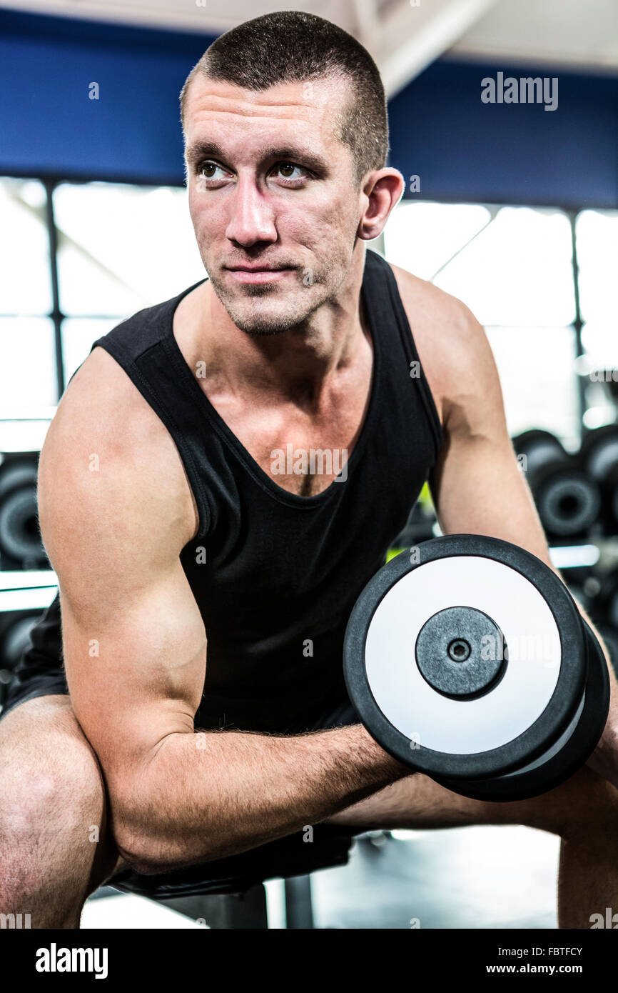 Muscular man exercising with dumbbells Stock Photo - Alamy