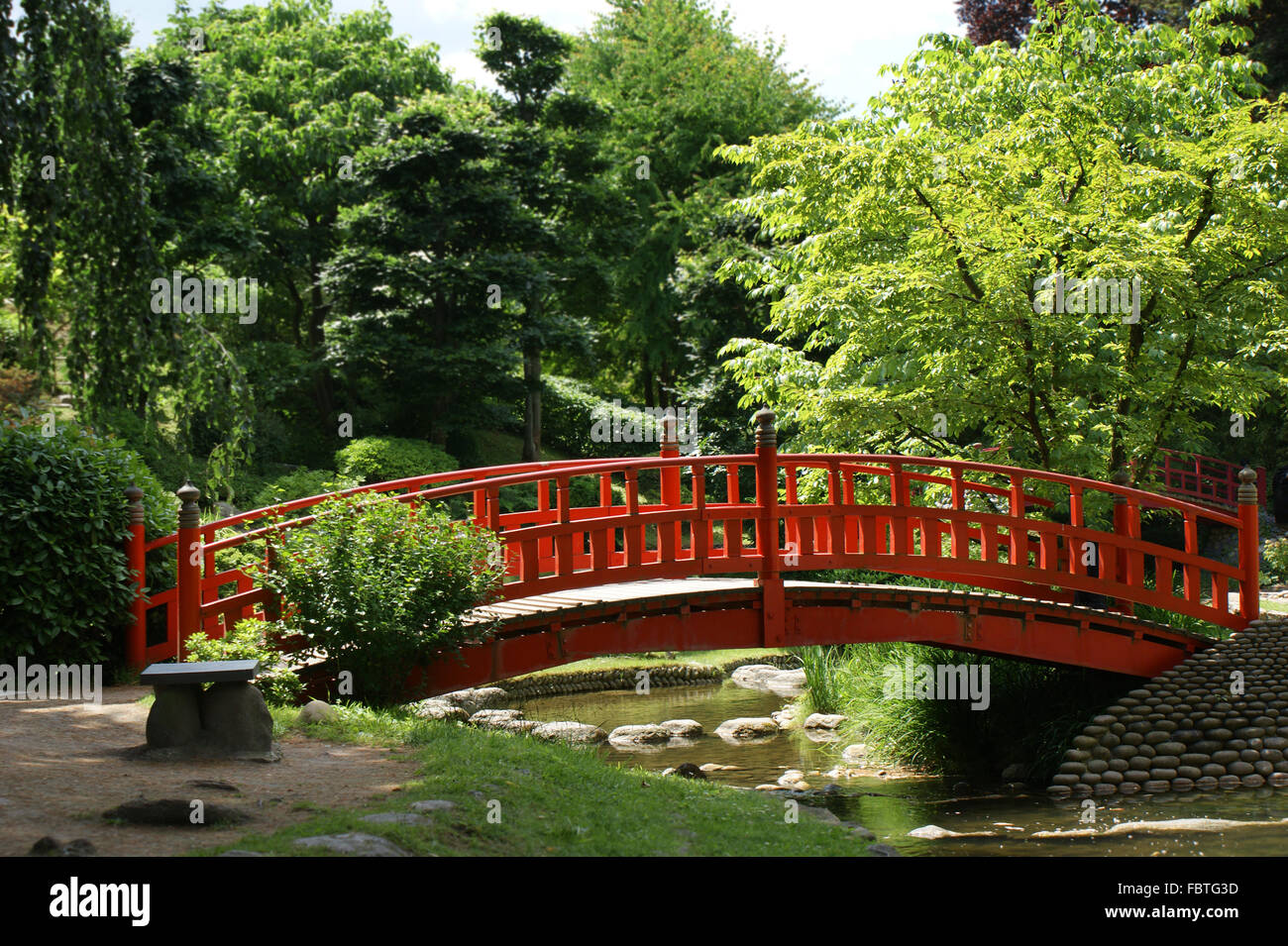 Red bridge in a japanese garden Stock Photo - Alamy