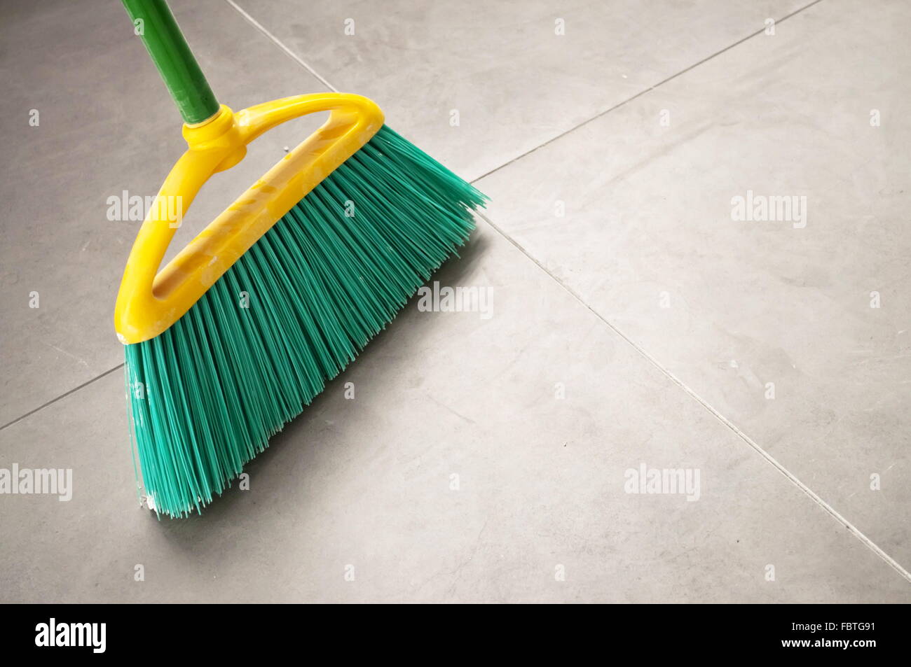 Green plastic broom during a home cleaning Stock Photo - Alamy