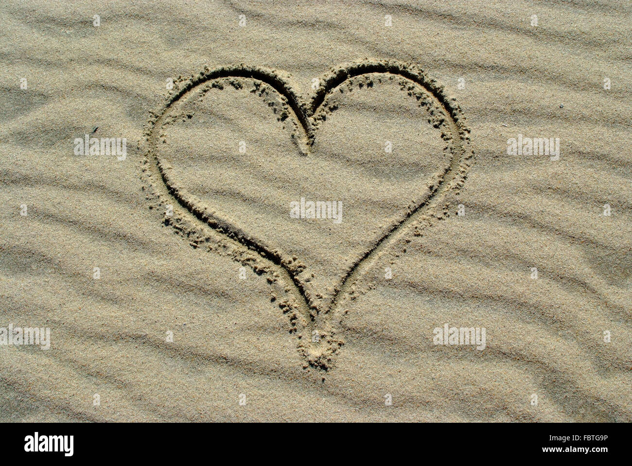 Heart in sand Stock Photo - Alamy