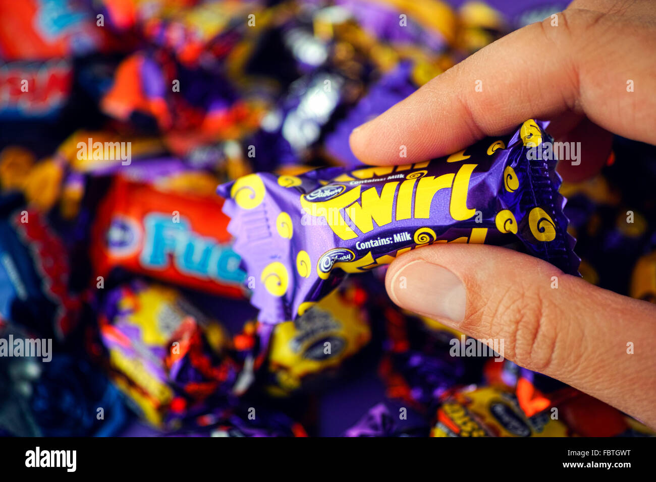 Paphos, Cyprus - November 27, 2015 Cadbury Twirl candy in womans hand ...