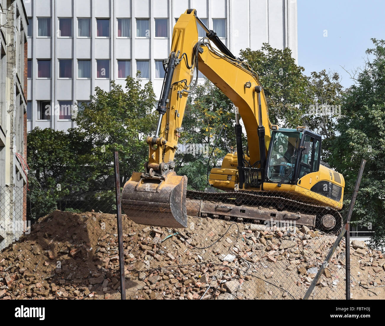 Excavator at the construction site in the city Stock Photo - Alamy