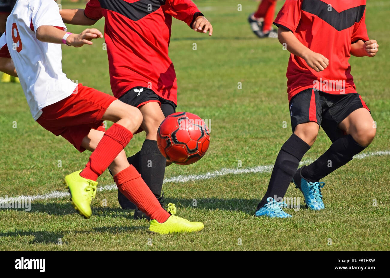 Young soccer players in action Stock Photo - Alamy