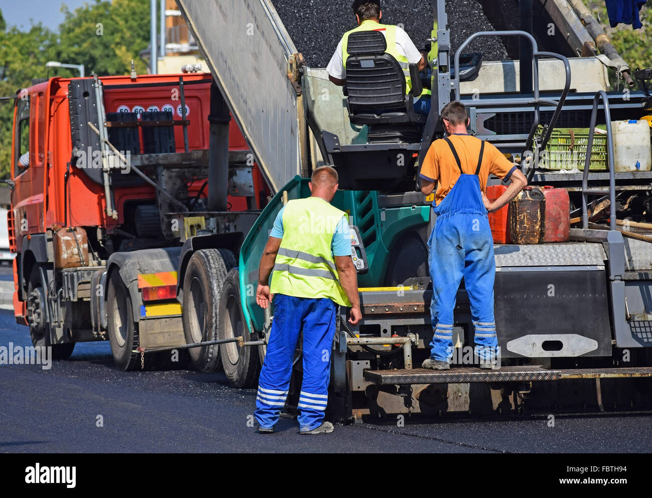 Asphalt paving vehicle at the road construction in the city Stock Photo ...