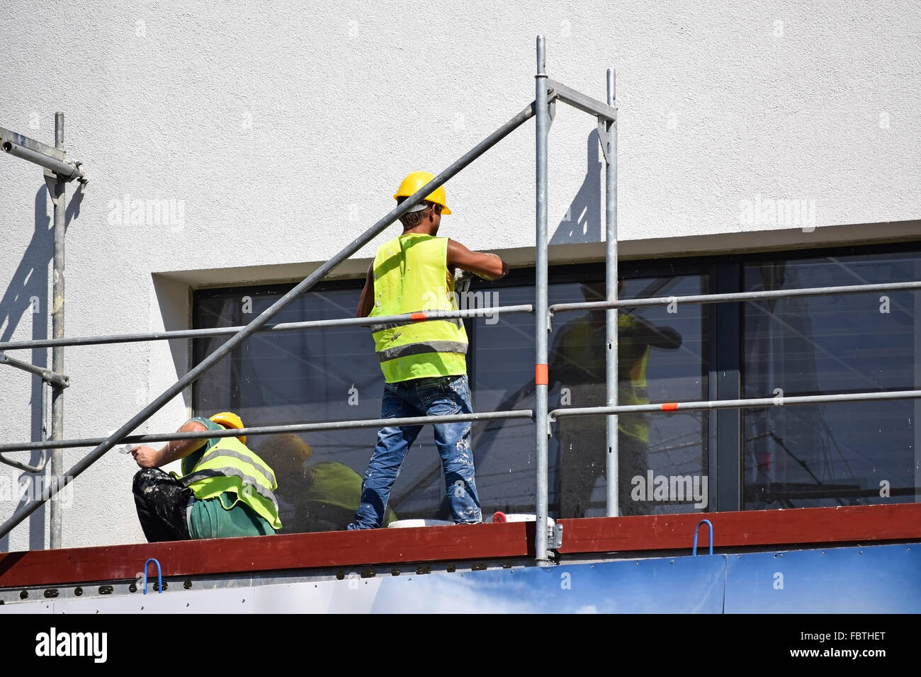Construction workers at work on a construction frame Stock Photo - Alamy