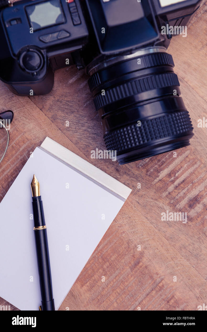 Photo camera on office table with notepad hi-res stock photography and ...
