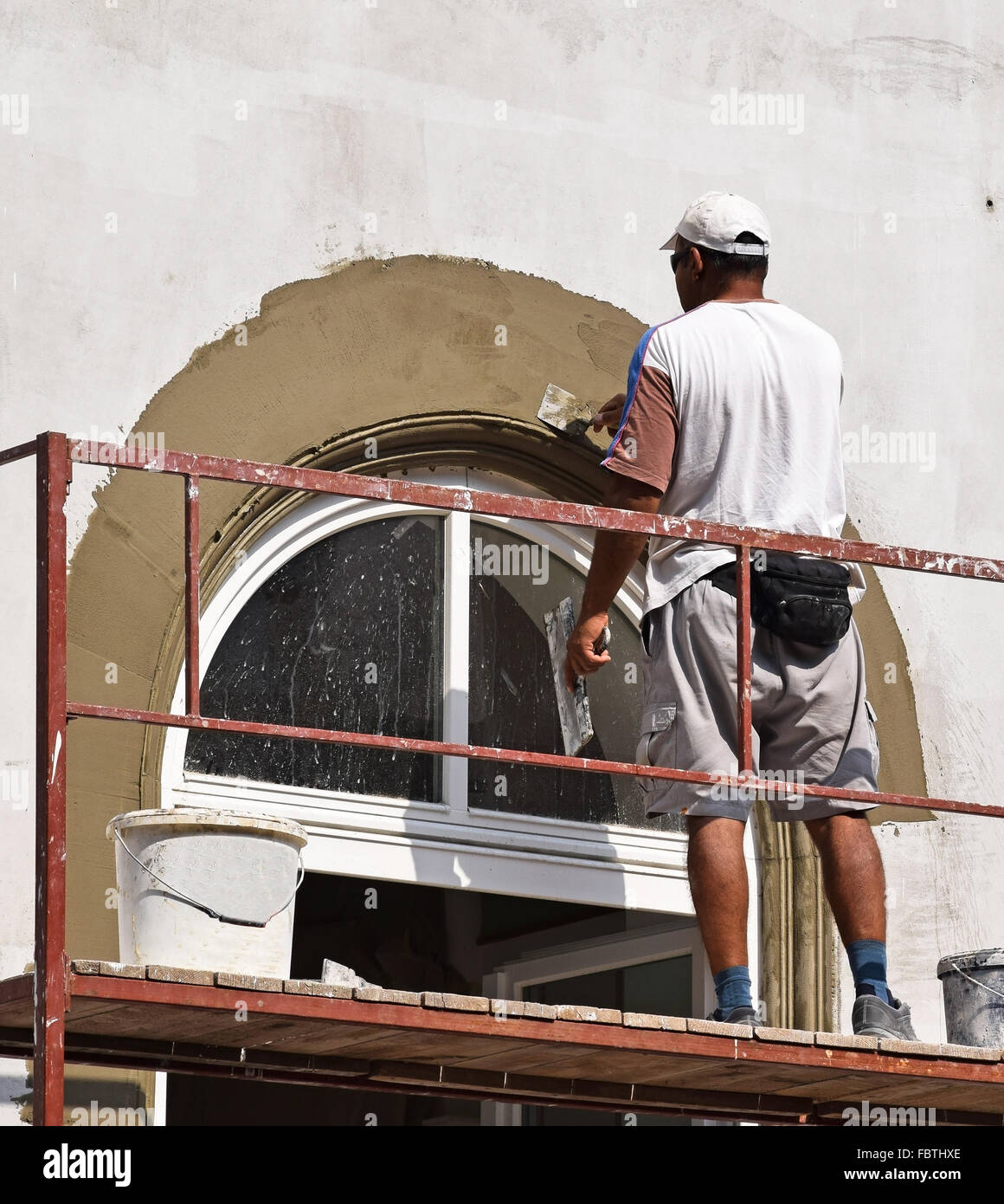 Construction worker works on a construction frame Stock Photo - Alamy