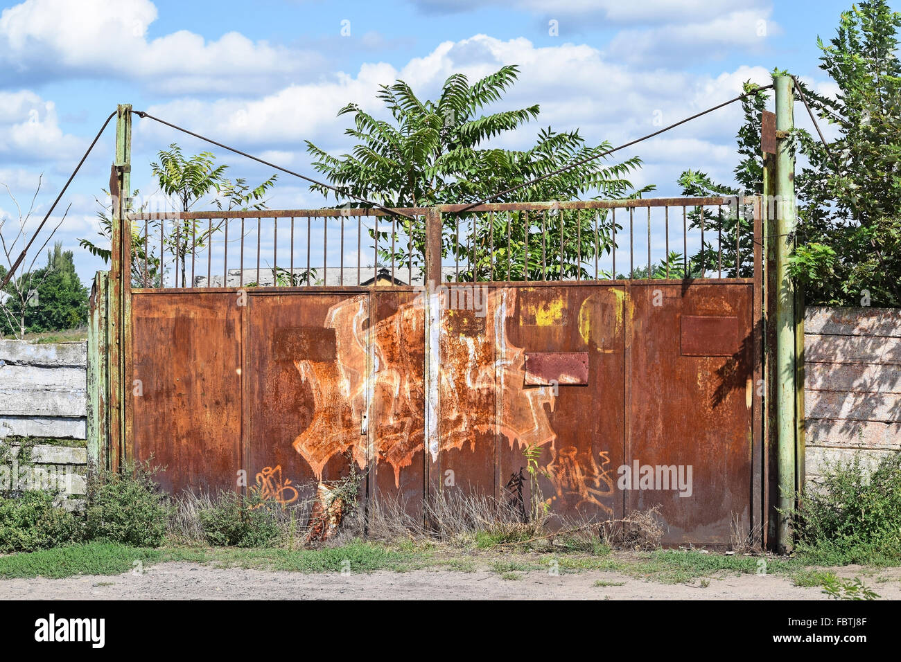 Rusty gate of the old factory building Stock Photo - Alamy