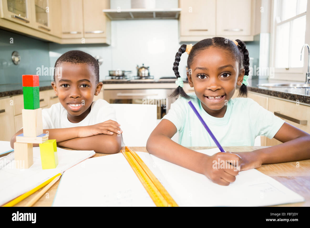 Children doing homework in the kitchen Stock Photo - Alamy