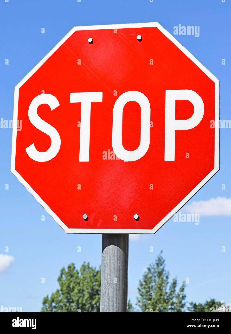 Stop sign at the road crossing Stock Photo - Alamy