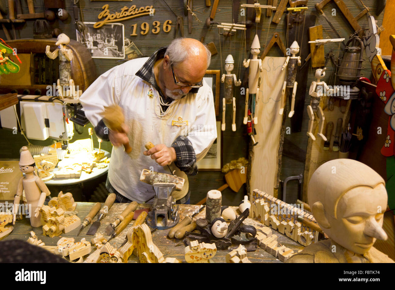 ROME, ITALY - DECEMBER 30 2014: Traditional craftsman carving wood in ...