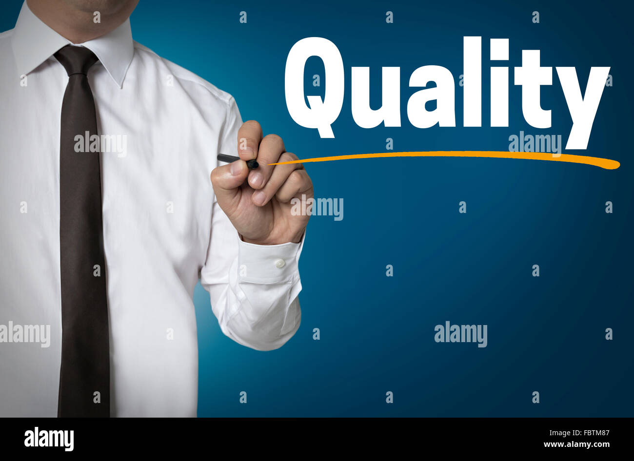 Quality is written by businessman background concept Stock Photo - Alamy