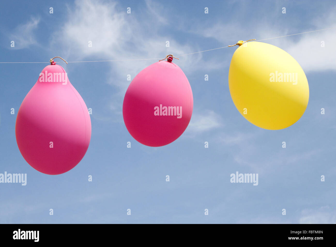 Balloons on a line Stock Photo - Alamy