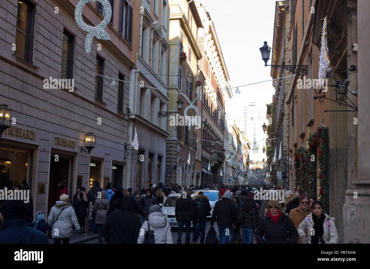 ROME, ITALY - DECEMBER 31 2014: Crowd of people walking in Via Condotti ...
