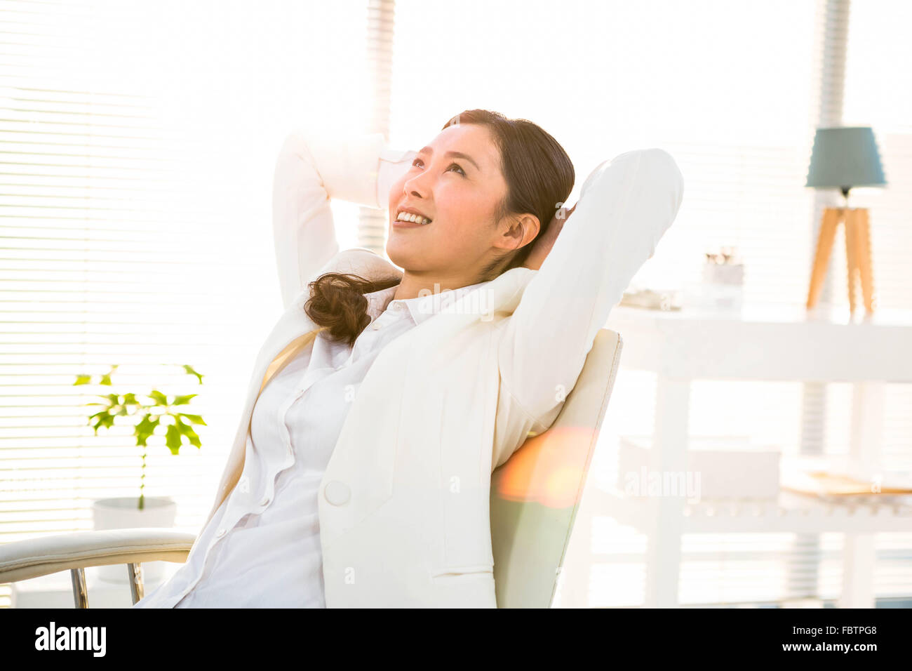 Smiling businesswoman relaxing herself Stock Photo - Alamy