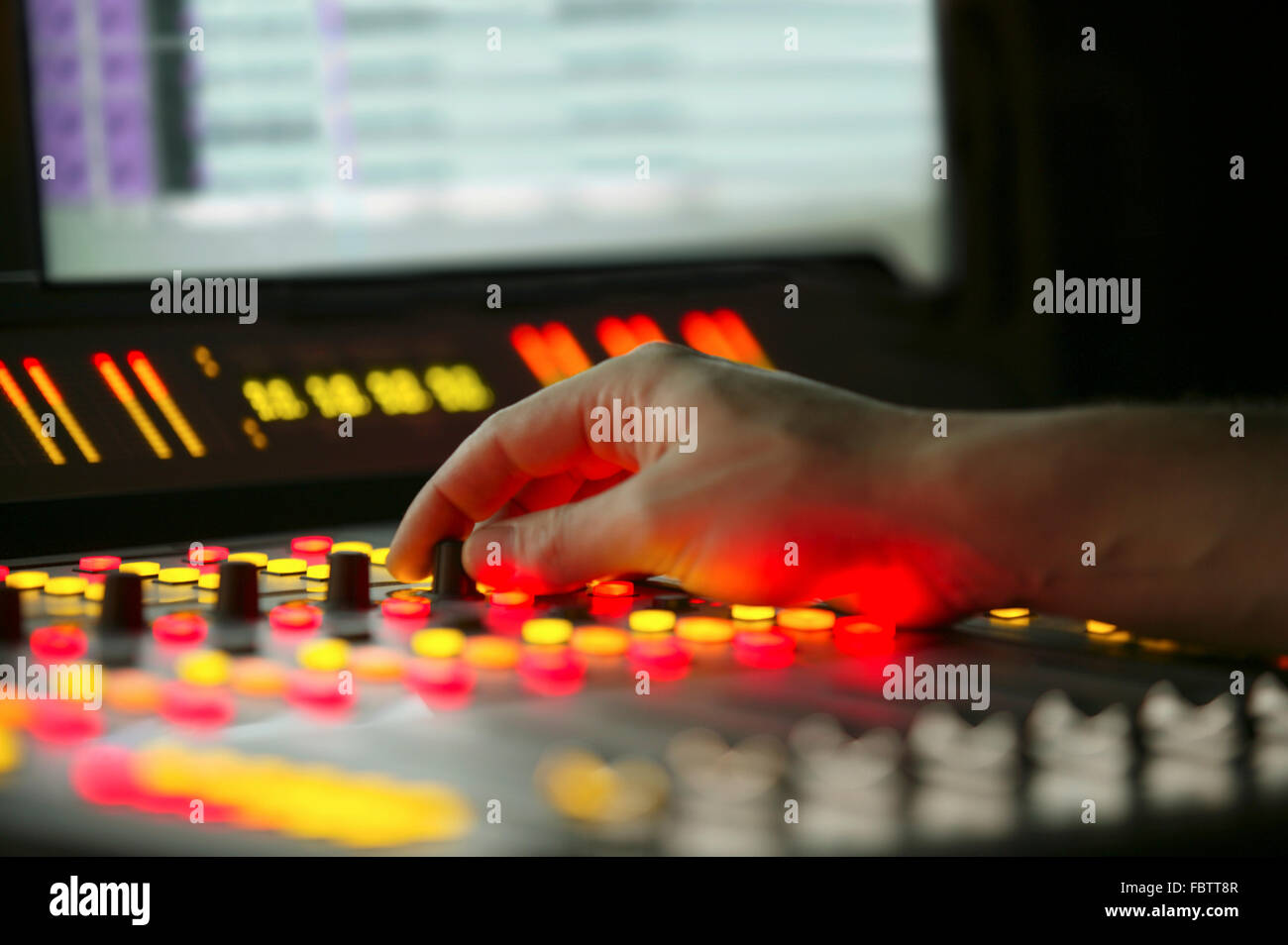Mixing board table with controls and hand Stock Photo - Alamy