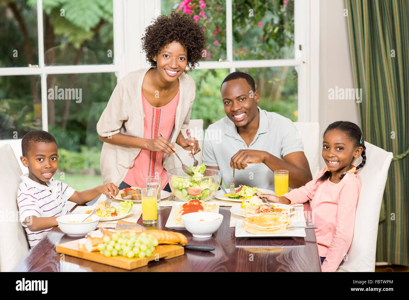 Happy family enjoying their meal Stock Photo - Alamy