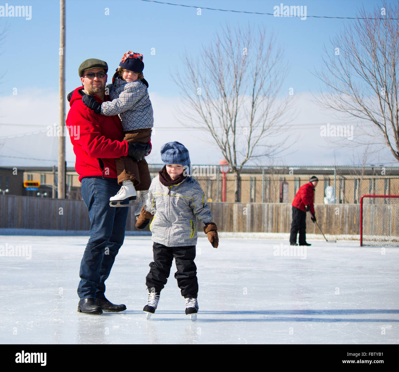 Happy family at the skating rink Stock Photo - Alamy