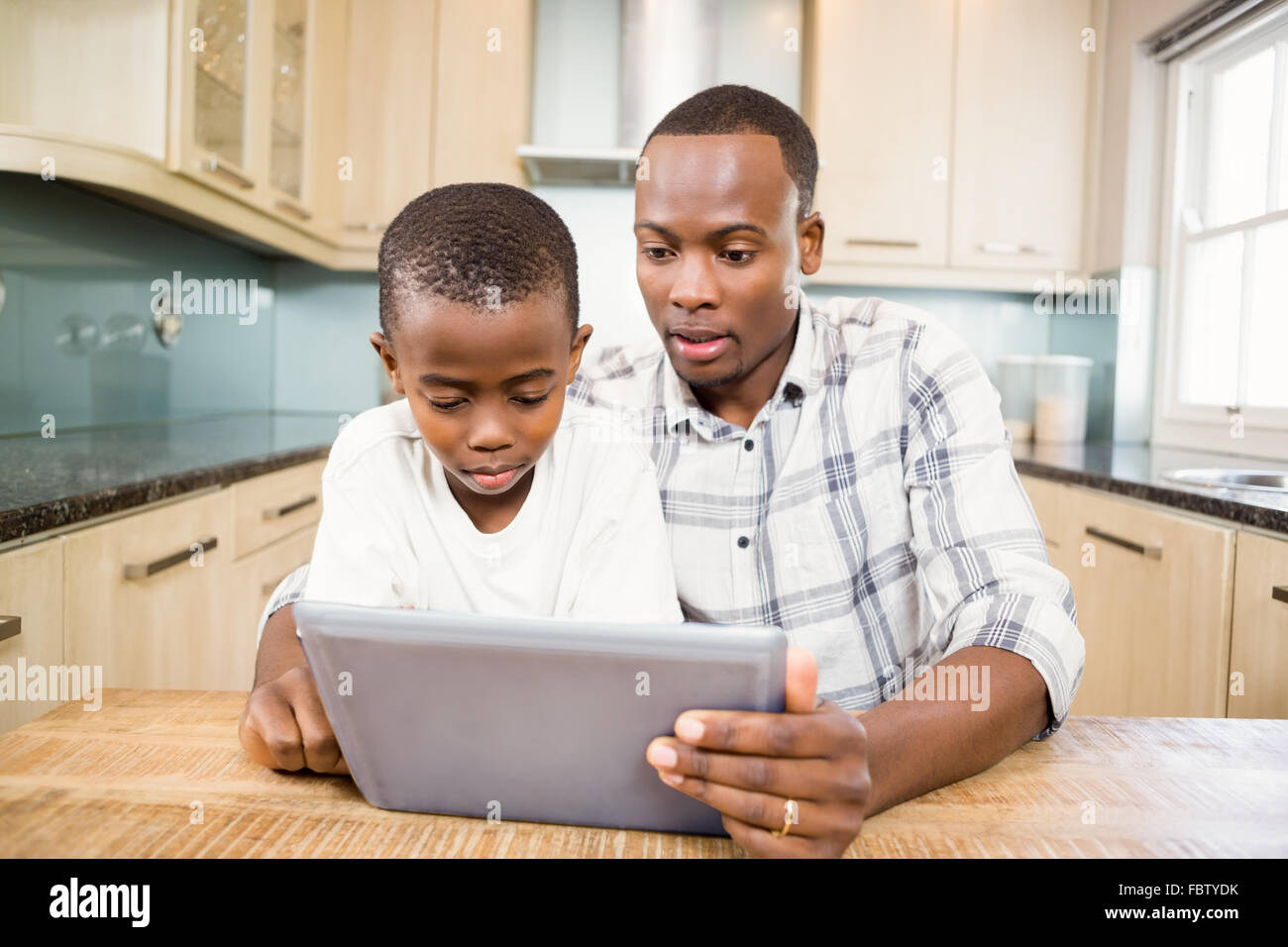 Father and son using tablet Stock Photo - Alamy
