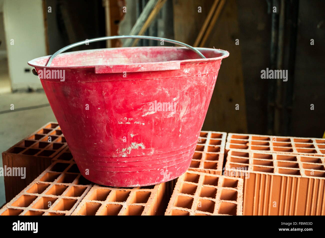Bucket on hollow bricks Stock Photo - Alamy