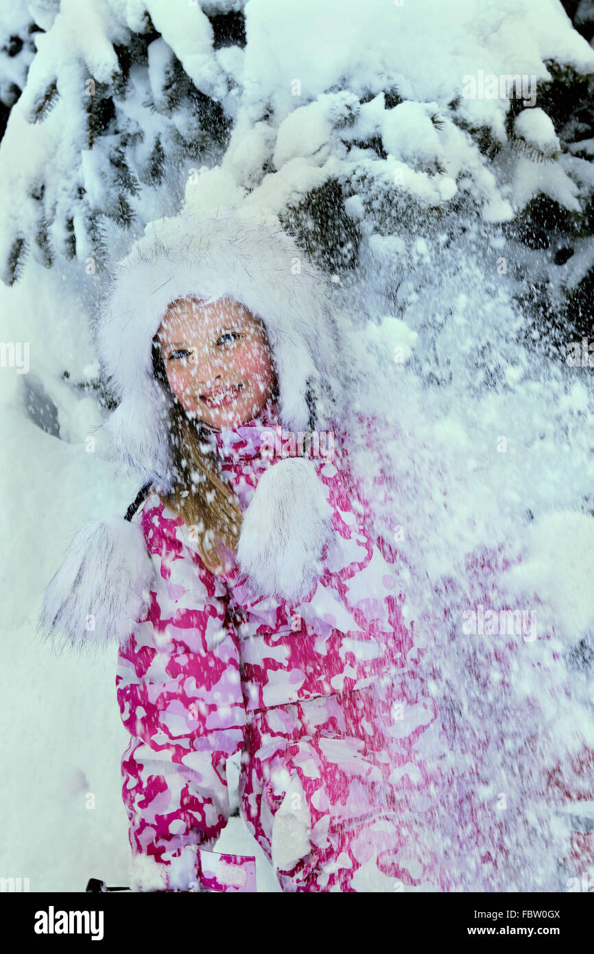 Little kid girl in winter clothes with falling snow on face Stock Photo ...