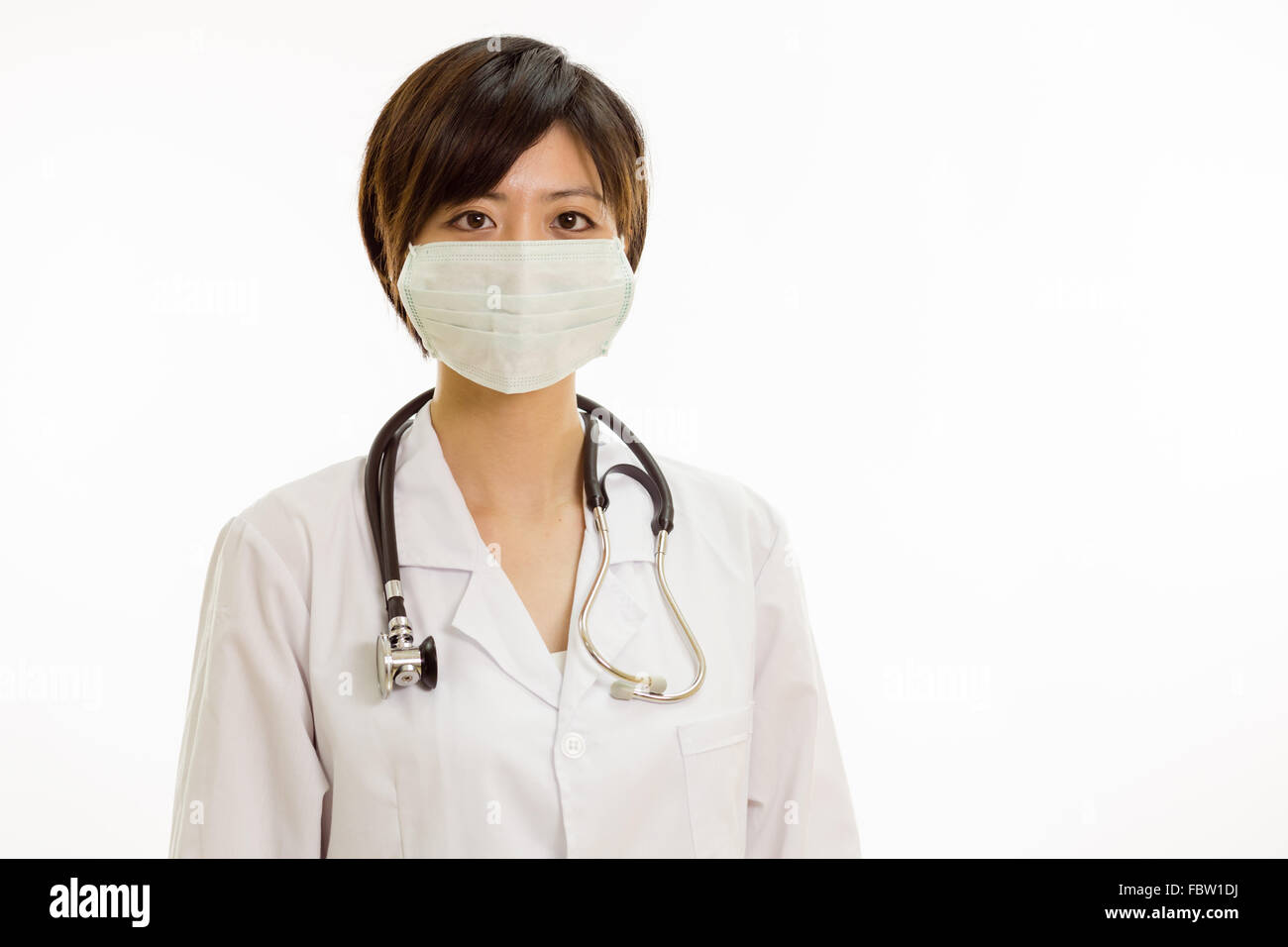 Chinese female doctor with stethoscope and surgical mask looking at ...