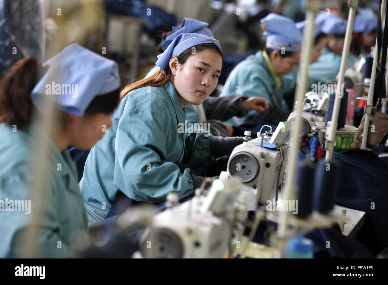 Female labours works at a cloth factory in Huaibei city, Anhui province ...