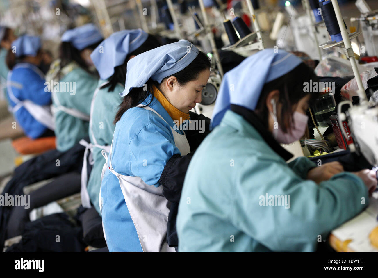 Female labours works at a cloth factory in Huaibei city, Anhui province ...